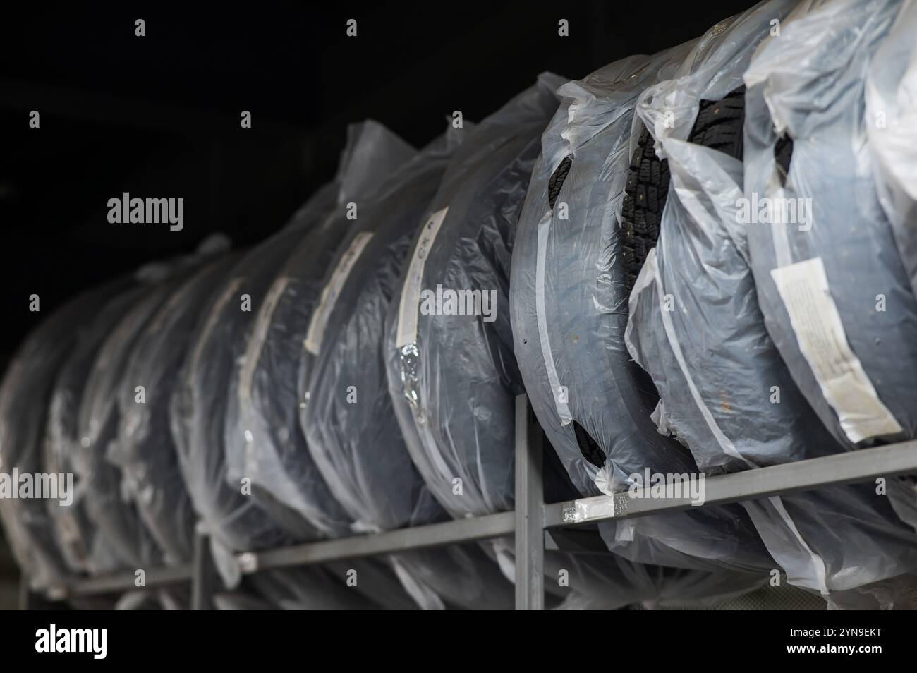 New car tires in plastic bags in a store Stock Photo - Alamy