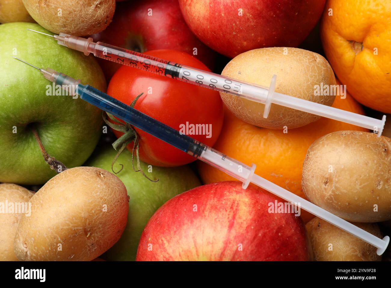 GMO concept. Different products and syringes as background, top view Stock Photo - Alamy