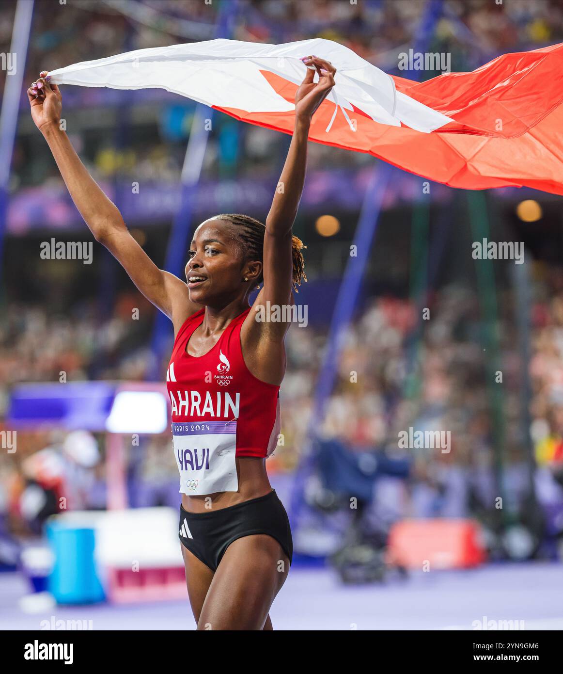 Winfred Yavi celebrating her medal with her country's flag at the Paris ...