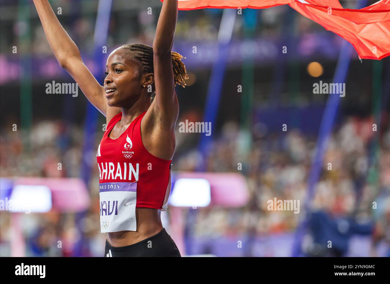 Winfred Yavi celebrating her medal with her country's flag at the Paris ...