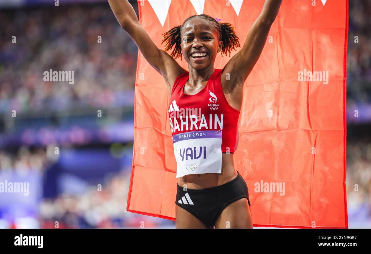 Winfred Yavi celebrating her medal with her country's flag at the Paris ...