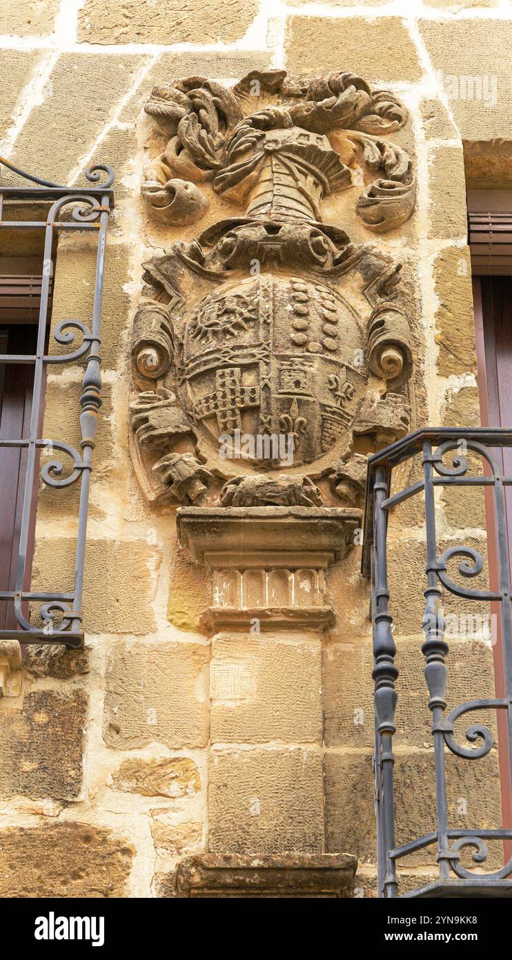 Old stone wall with a heraldry coat of arms as decoration. The wall is ...