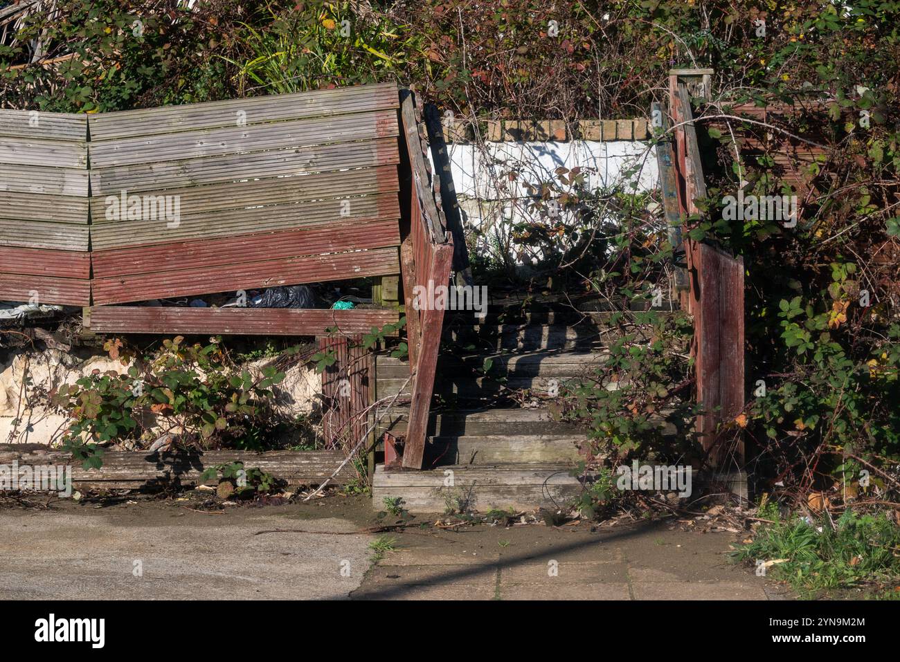 Old rusted and derelict wall and staircase outside of an empty building ...