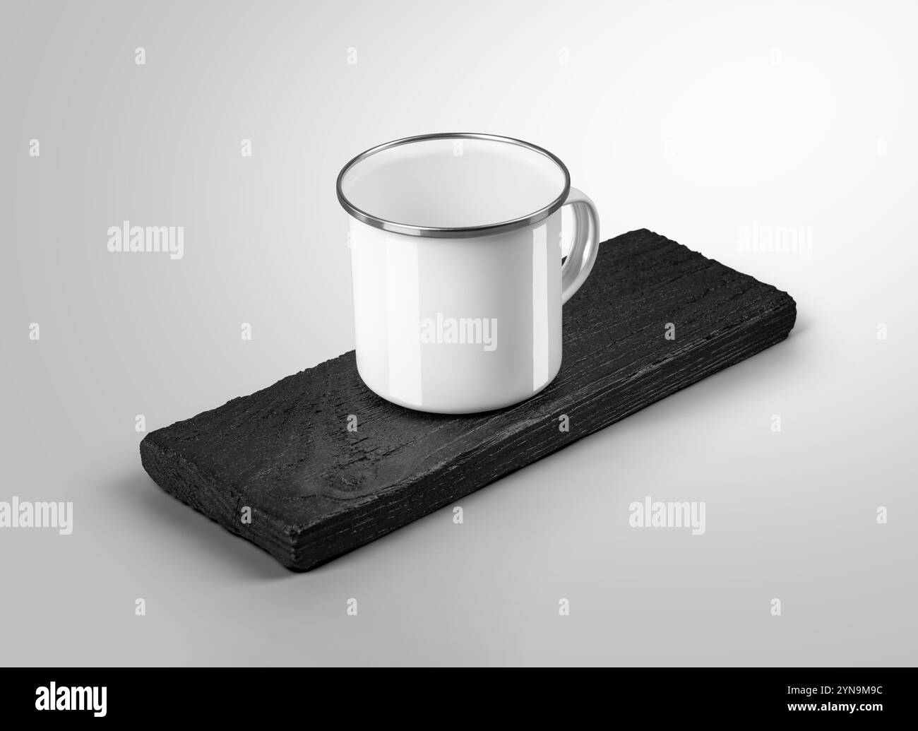 Mockup of a white metal mug in the center of a wooden burnt board, top ...