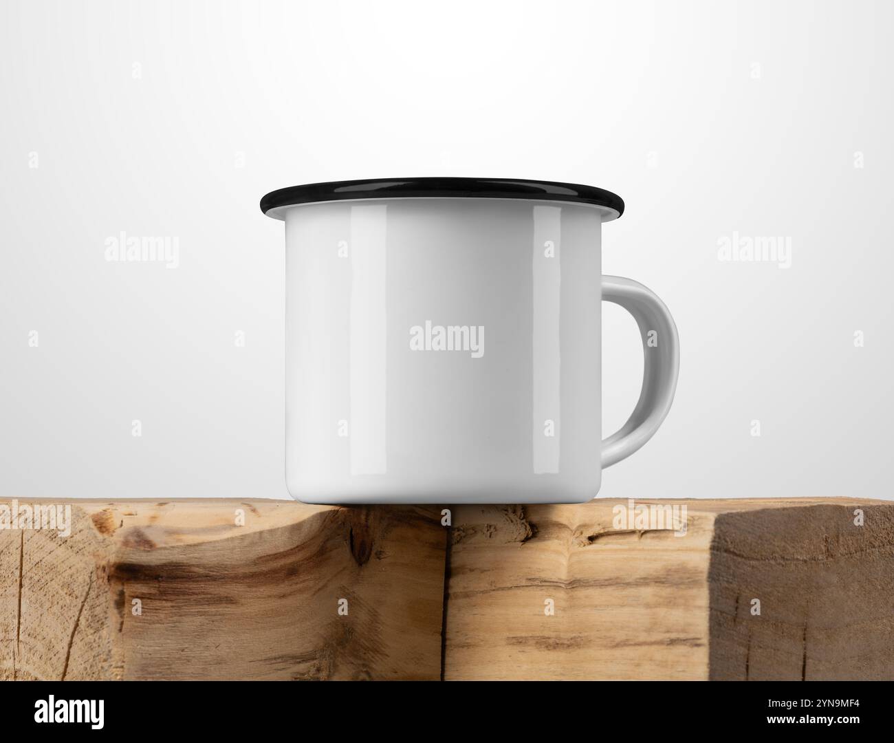 Mockup of white enamel mug with black rim, on textured old wood beam ...
