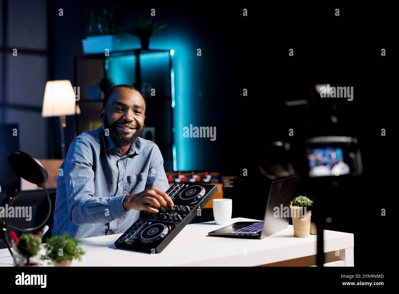 African american artist filming DJ mixing tutorial in recording studio ...