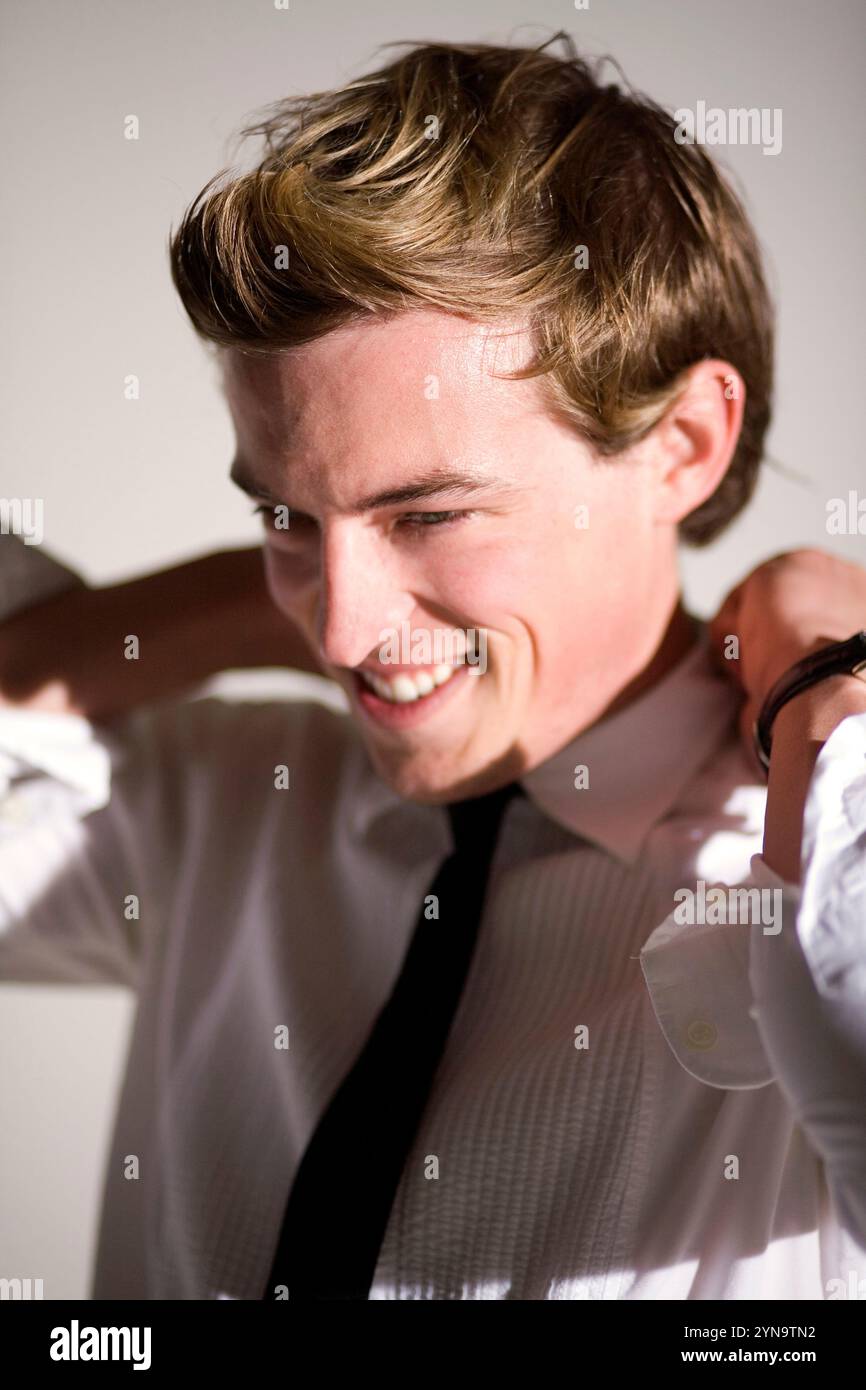 A male model fixing his collar during a photo shoot at a studio in Los ...