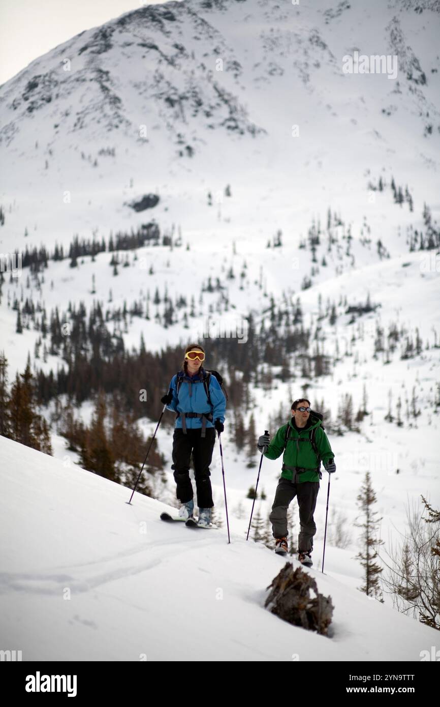 Two people skiing during the winter in the mountains in Baikalsk ...