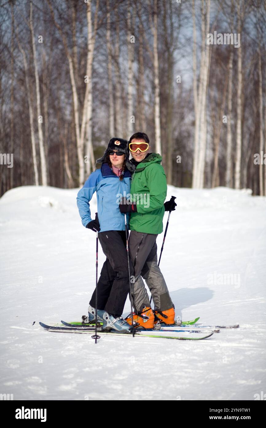 A couple taking a break while skiing in the mountains in Baikalsk ...