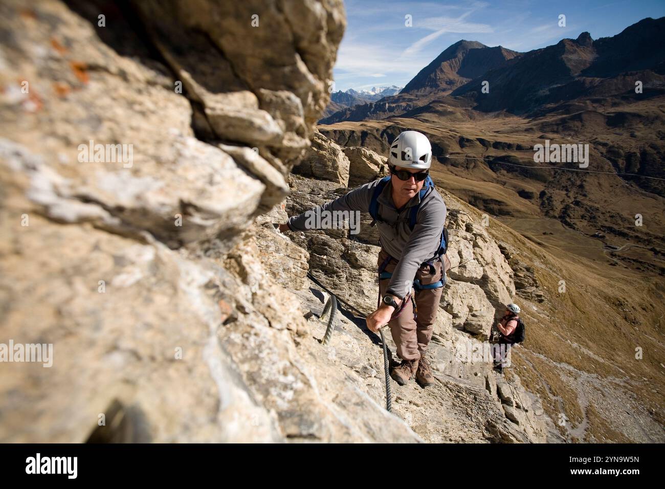 Two people climbing up a cliff while engaging in the sport of Via ...