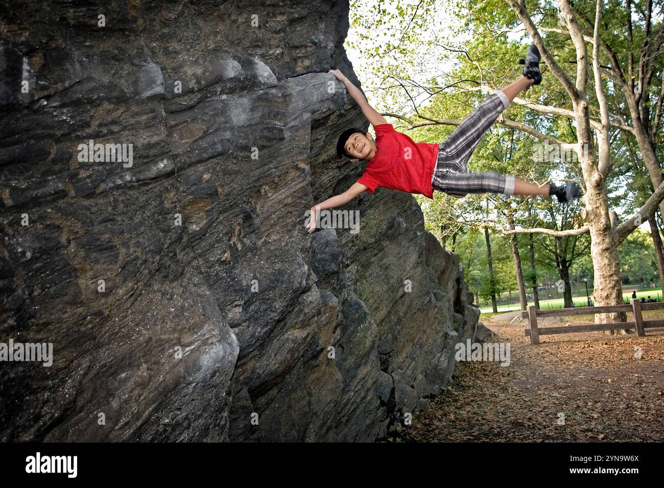 A young climber bouldering and having fun in Central Park Stock Photo ...