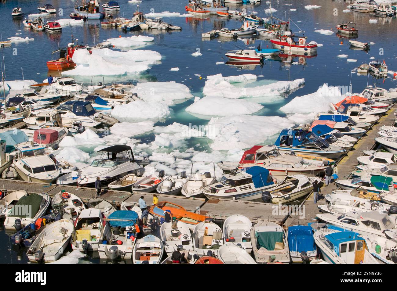 Inuit boats and icebergs in Illulisat harbour on Greenland Stock Photo ...