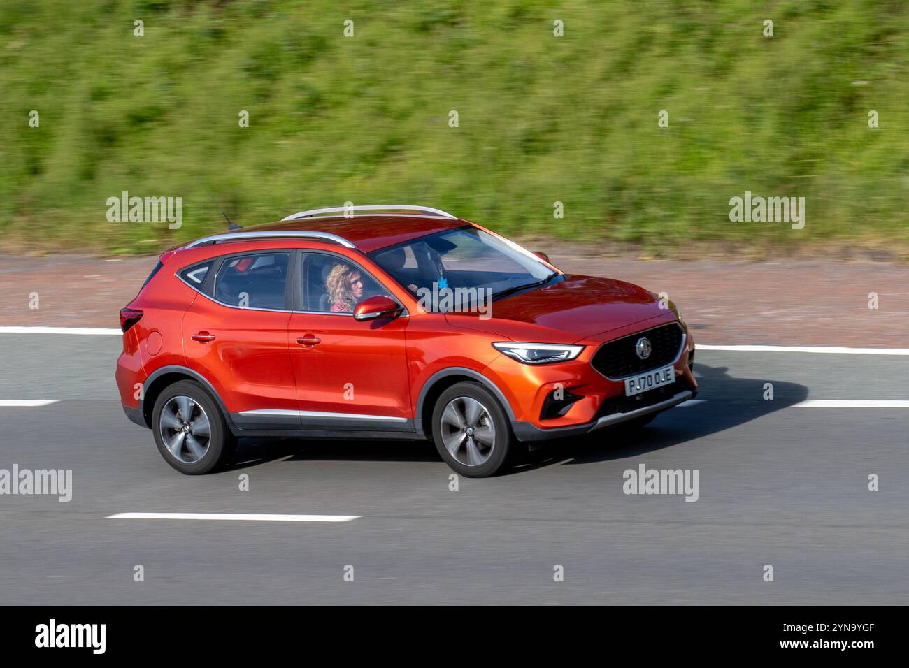 2021 Orange MG ZS Excite T-Gdi Auto, 1.0 L 3-cylinder compact crossover SUV; travelling on the ...