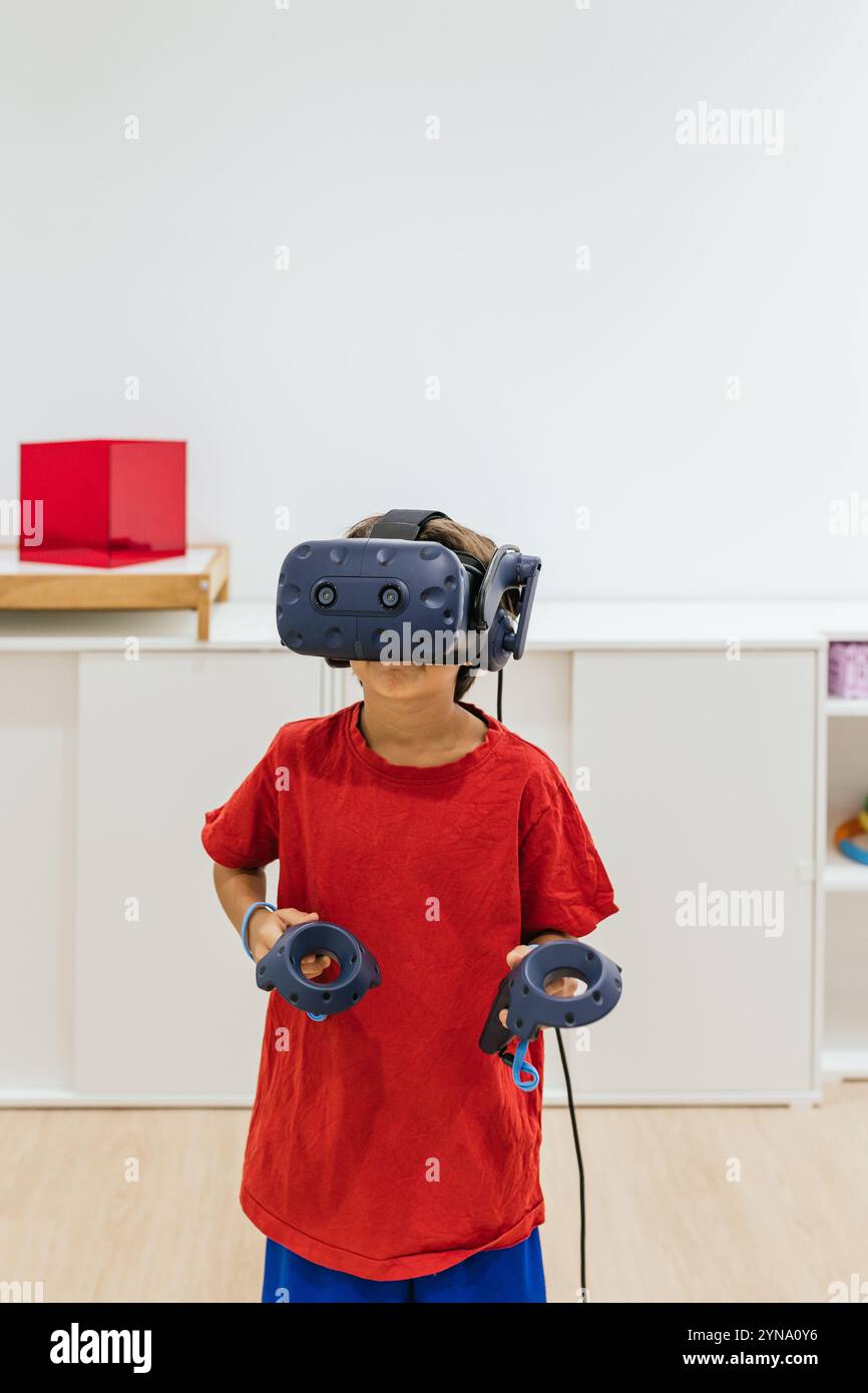 Child patient using virtual reality glasses during vision therapy ...