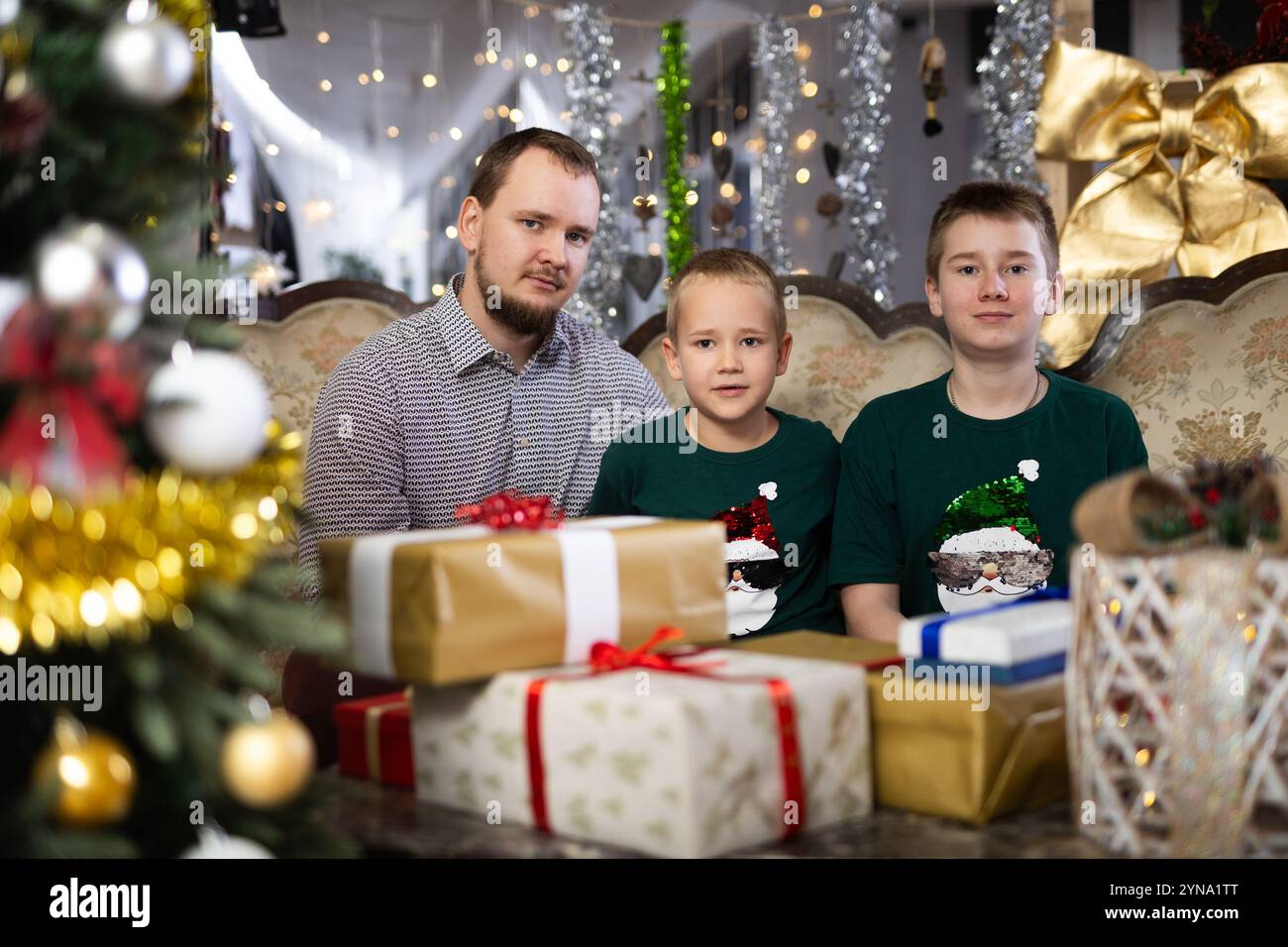 Happy father with children celebrating Christmas and giving each other ...