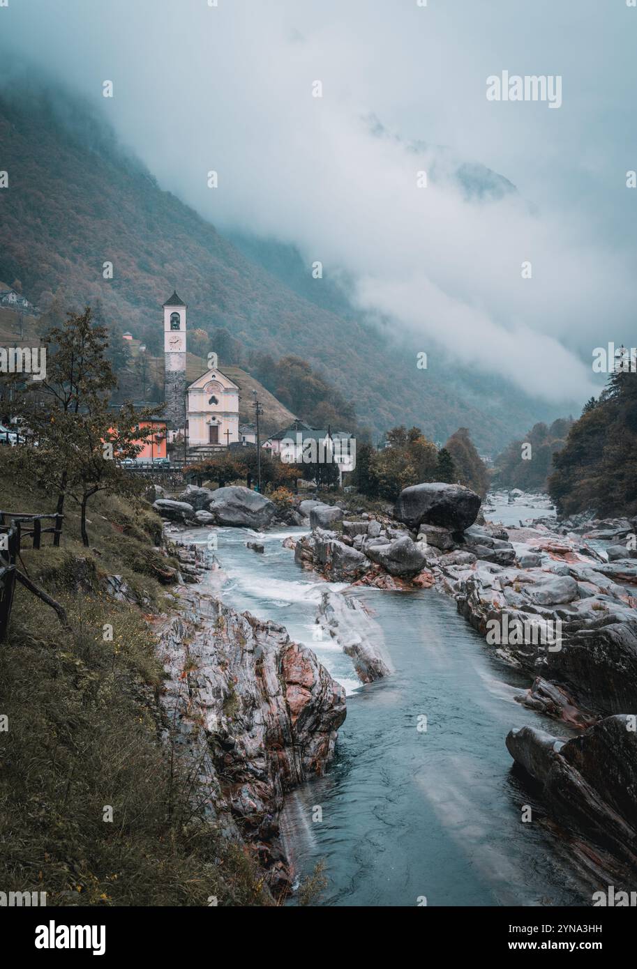 A rainy autumn landscape with vibrant foliage surrounds a gently ...