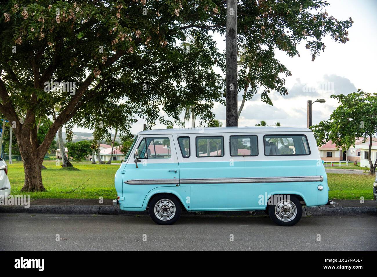Vintage teal van parked under trees in Guam during the afternoon Stock ...