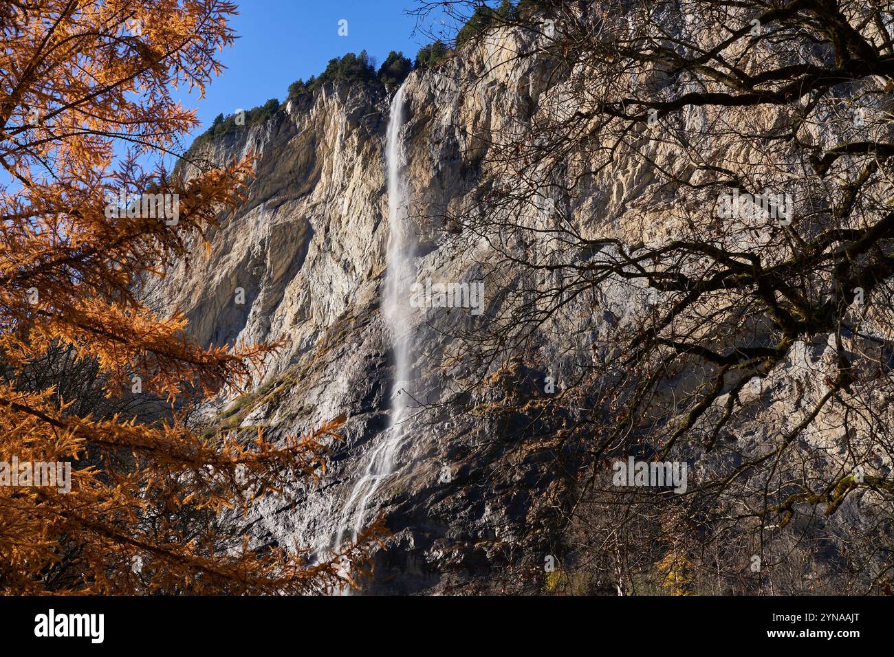 Waterfall on a cliff in the Swiss alps in a sunny November day Stock ...