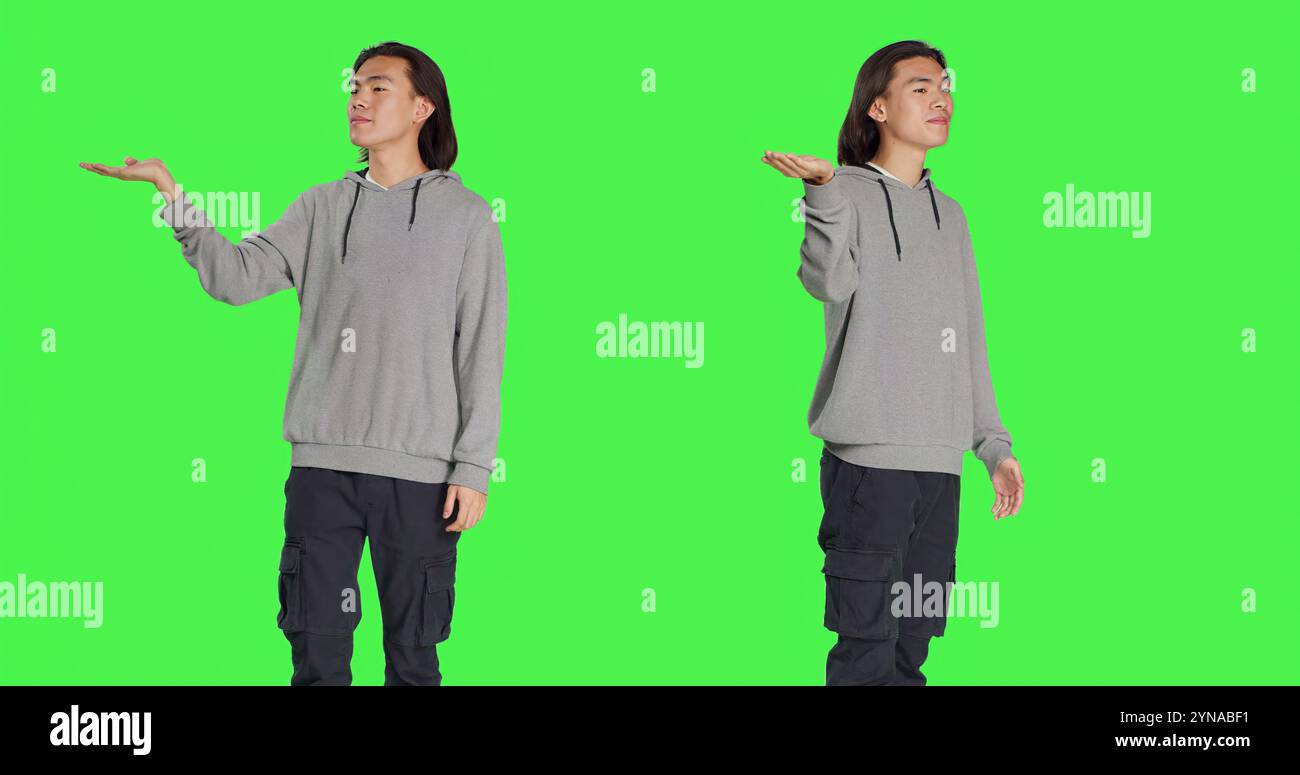 Asian man presenting marketing ad over greenscreen backdrop, creating ...