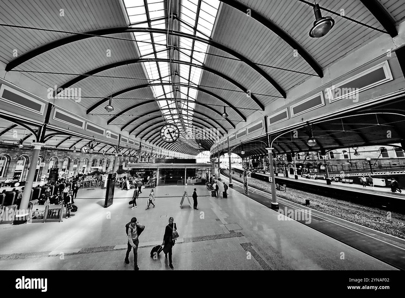 Newcastle Central Rail Station platforms amid cafes with the passengers ...