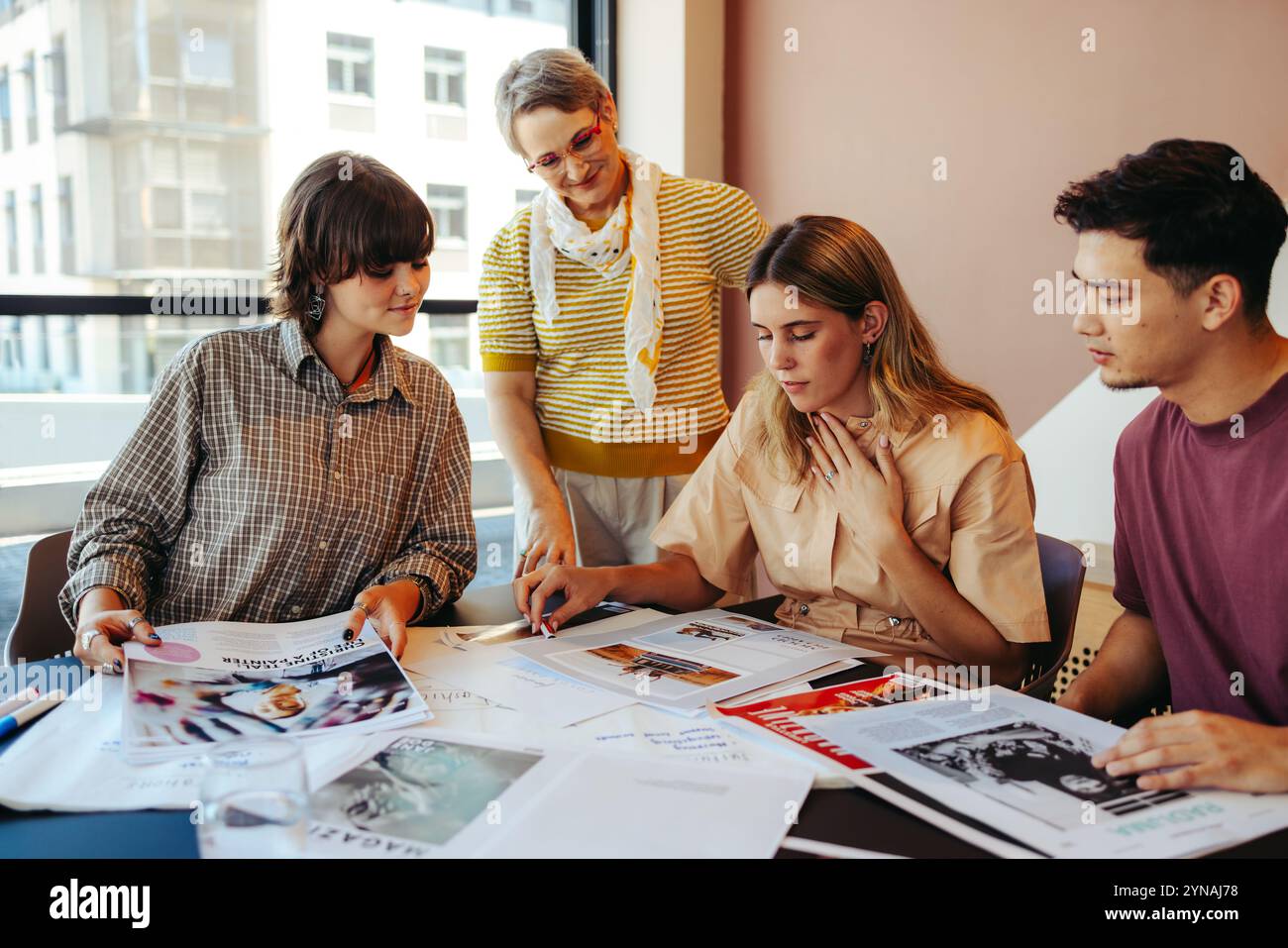High school students work together on a classroom project, surrounded by city views, fostering ...