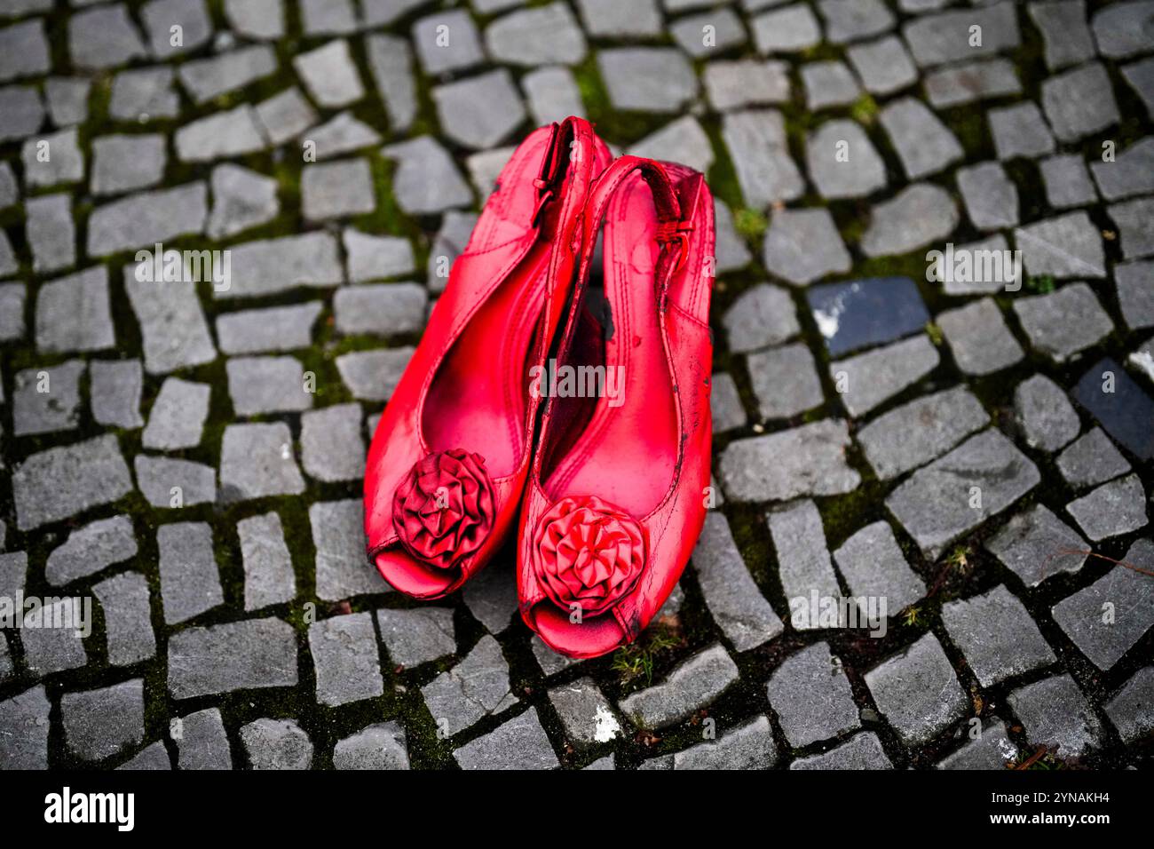 Red shoes placed on the ground as a symbol against the violence on ...