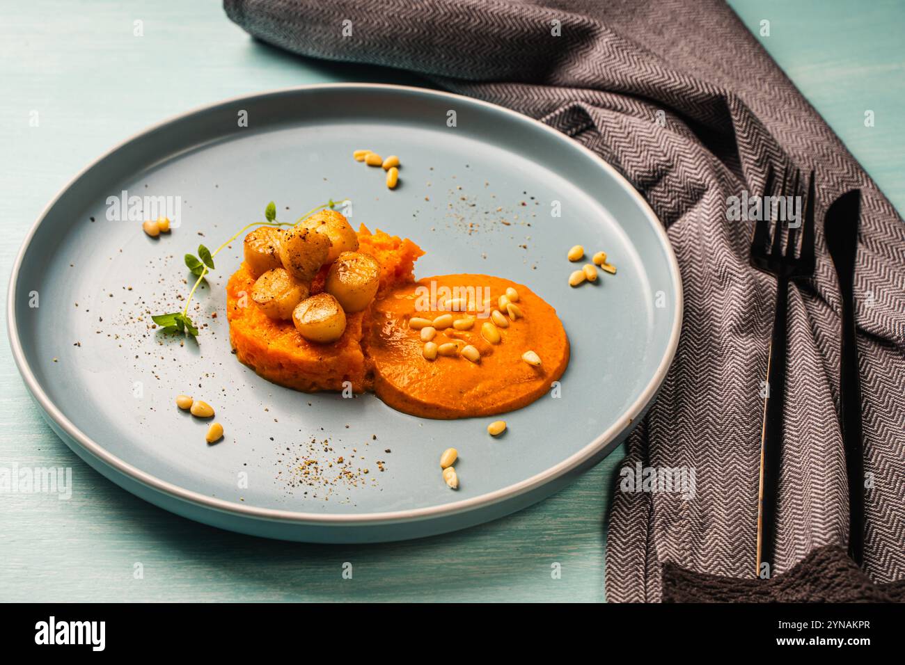 Scallops with carrot puree with Romesco sauce, fesalis and pine nuts on ...