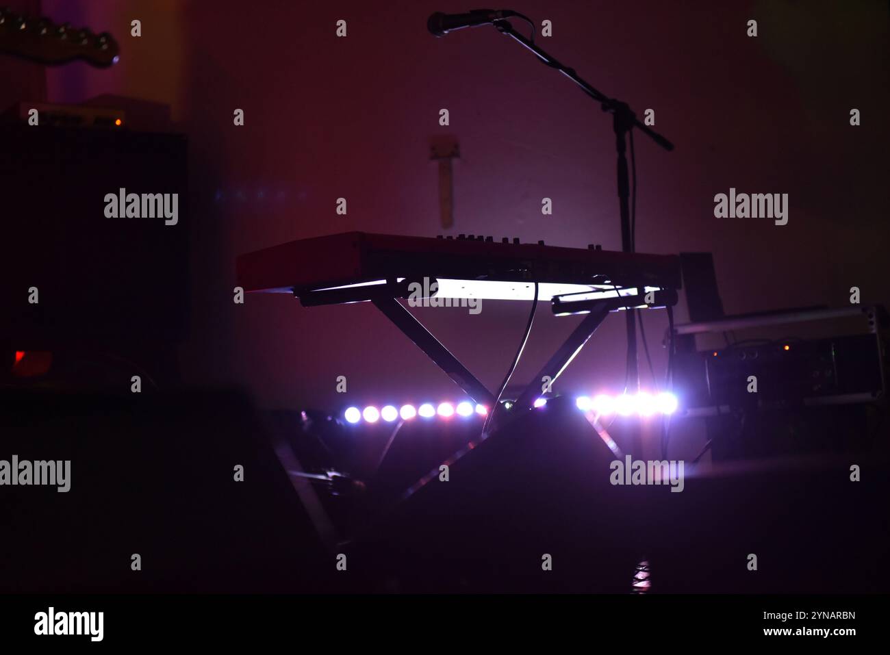 Keyboard instrument and microphone in stage lights Stock Photo - Alamy