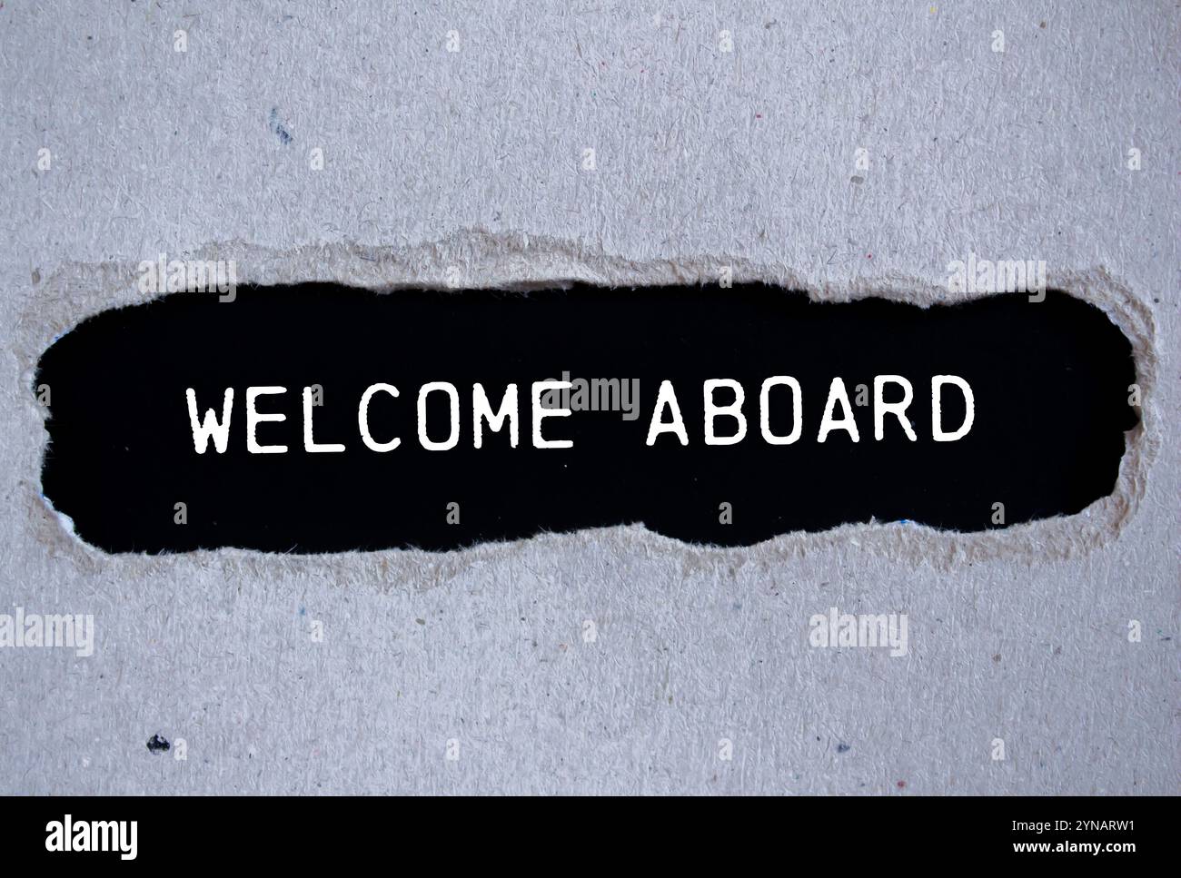 Welcome aboard message written on ripped torn gray paper with black ...