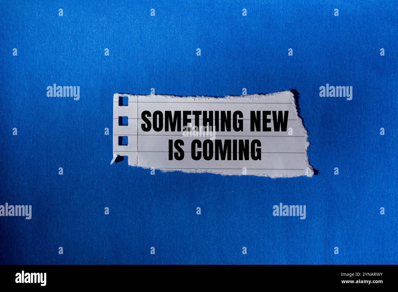 Something new is coming message written on ripped torn paper piece with ...