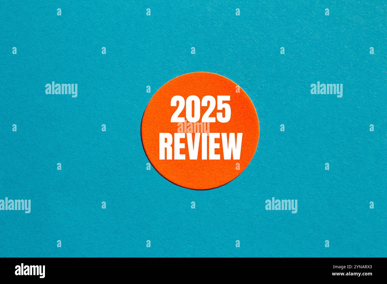 2025 review message written on round orange sticker with blue ...