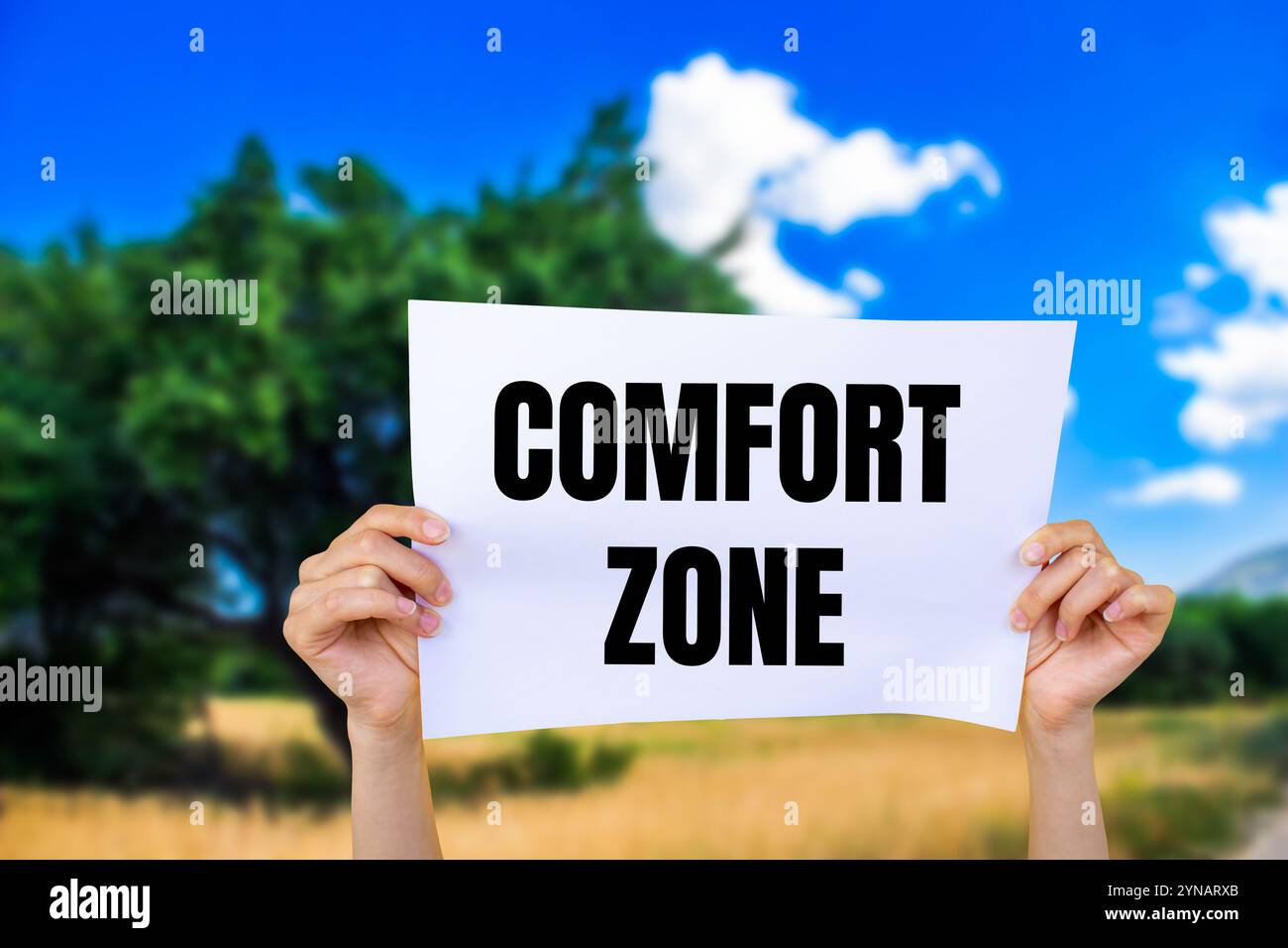 Comfort zone message written on white paper with nature background. Conceptual comfort zone ...