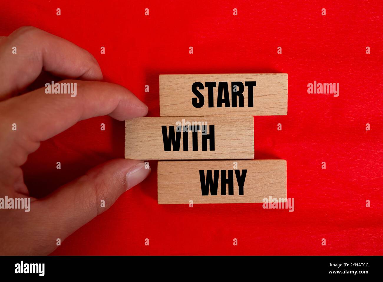 Start with why message written on wooden blocks with red background ...