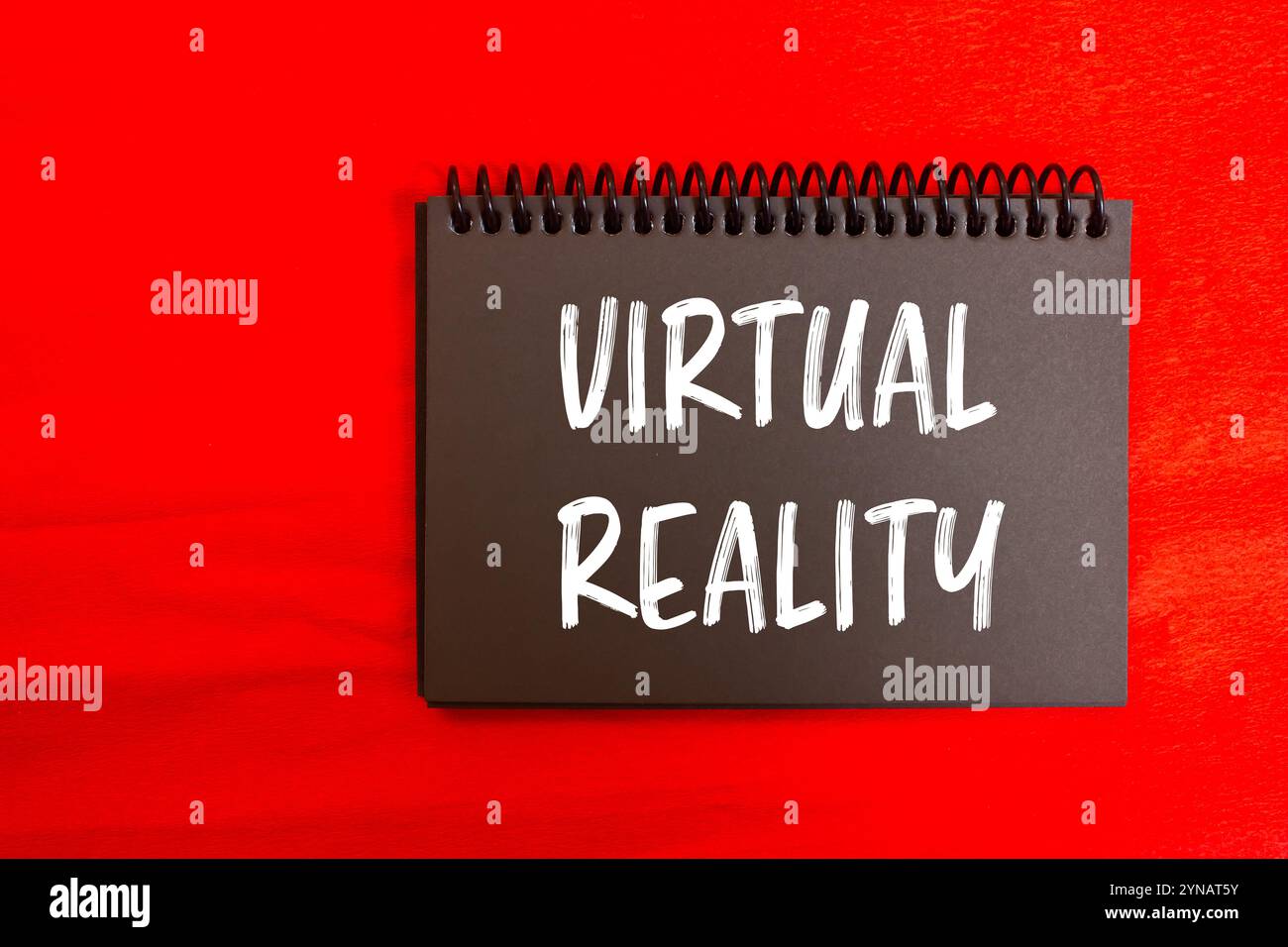 Virtual reality message written on black notebook page with red ...