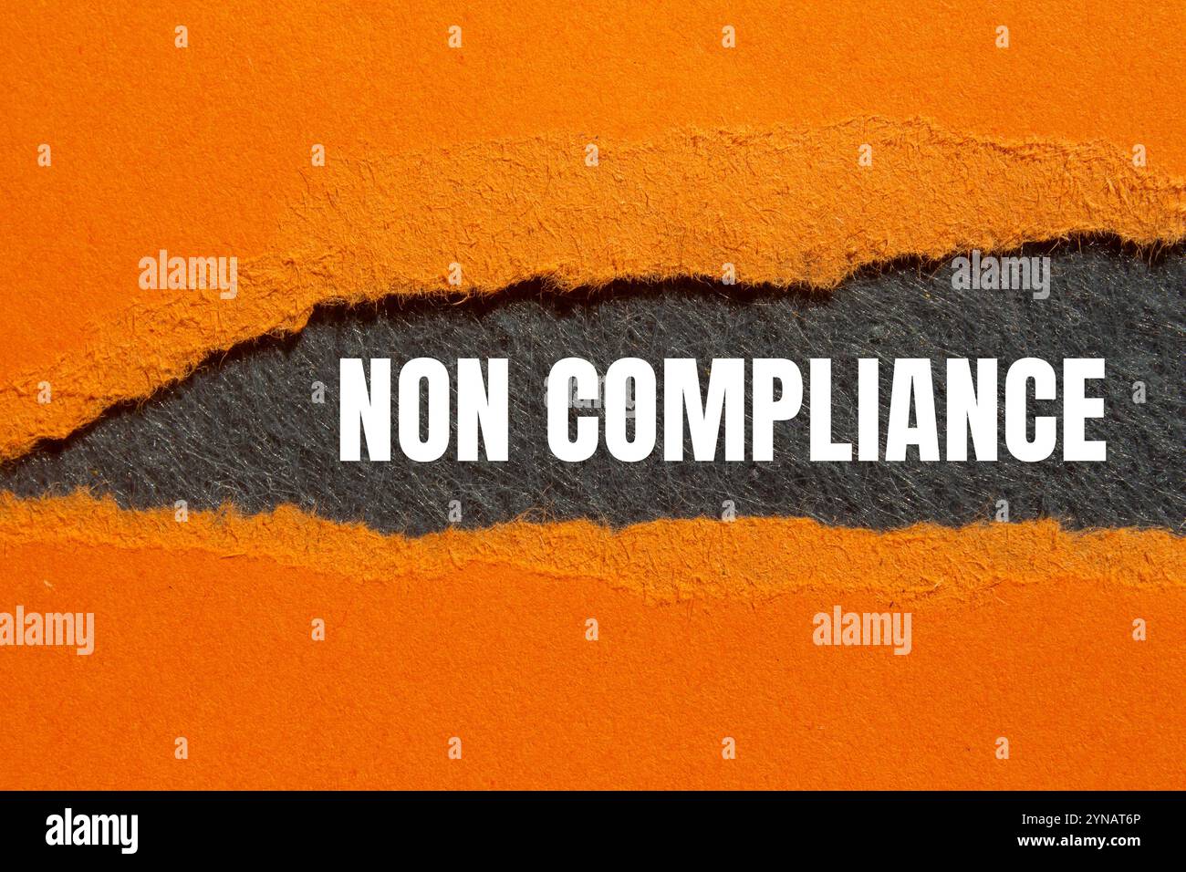Non compliance message written on ripped torn orange paper with gray background. Conceptual non ...