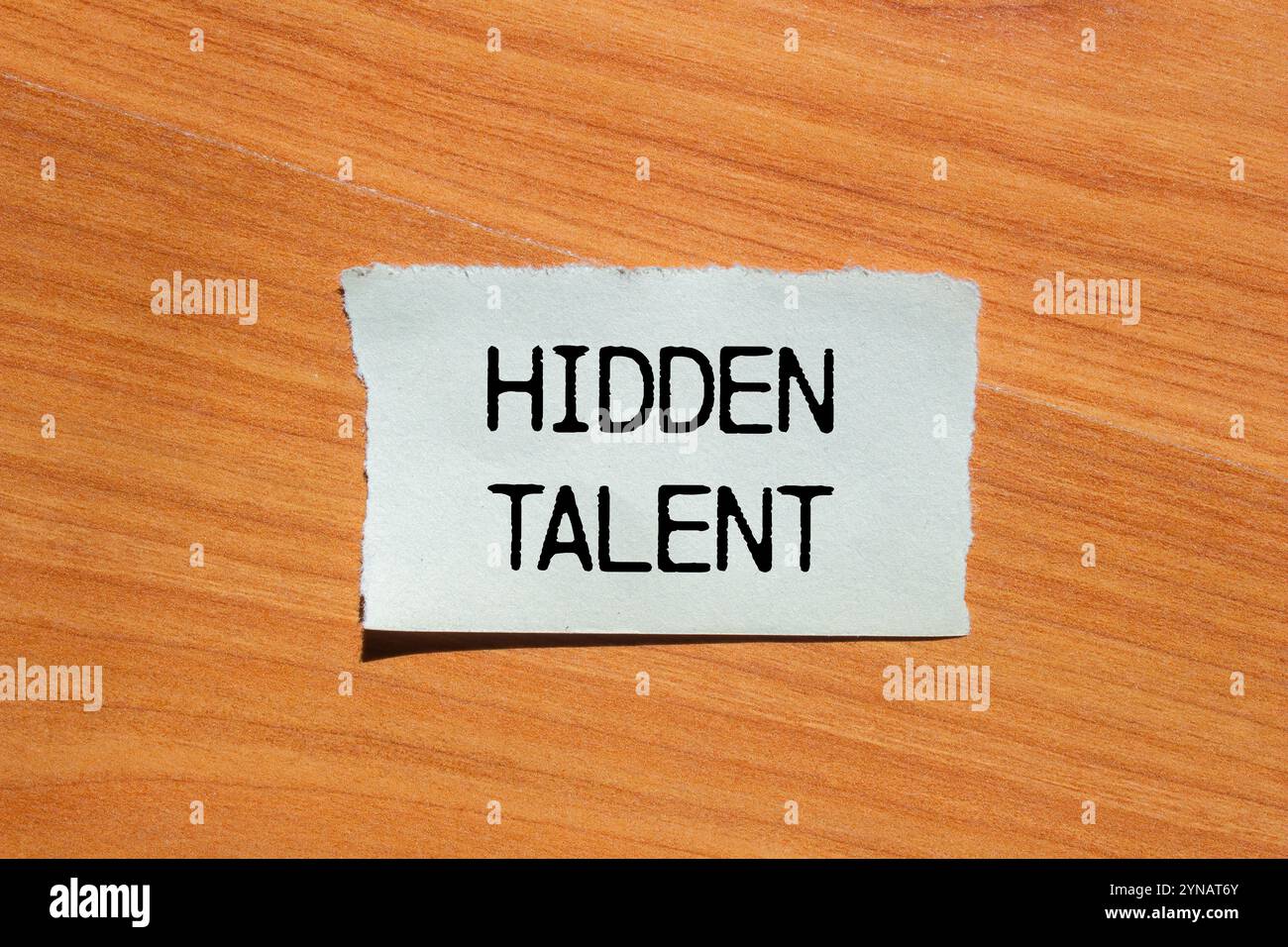 Hidden talent message written on ripped torn paper piece with wooden ...