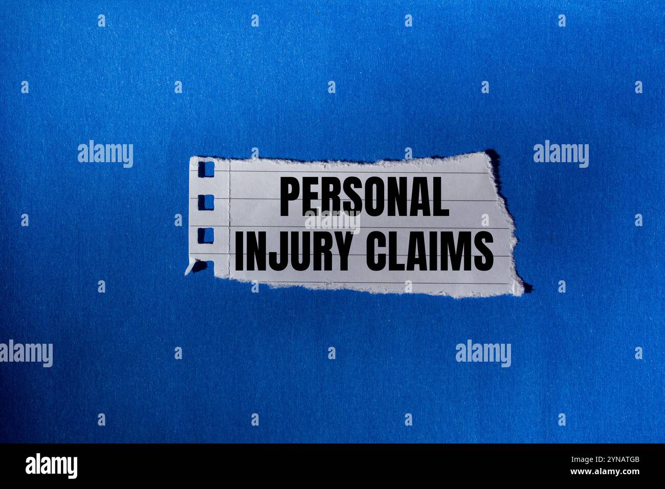 Personal injury claims message written on ripped torn paper piece with ...