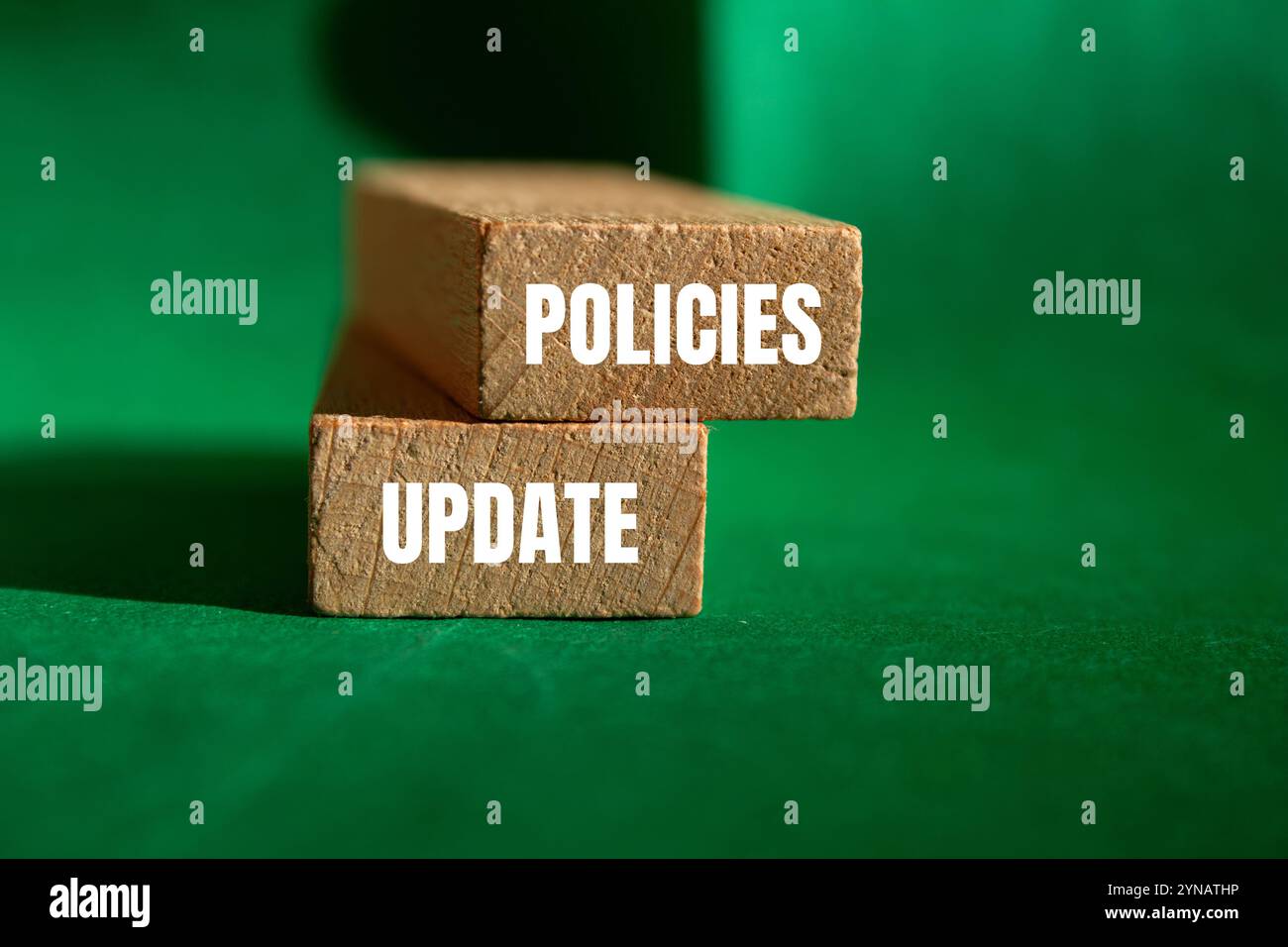 Policies update message written on wooden blocks with green background. Conceptual policies ...