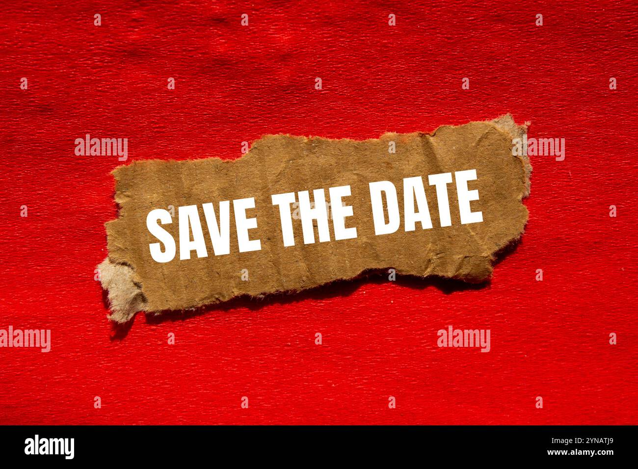 Save the date message written on ripped torn cardbaord paper piece with ...
