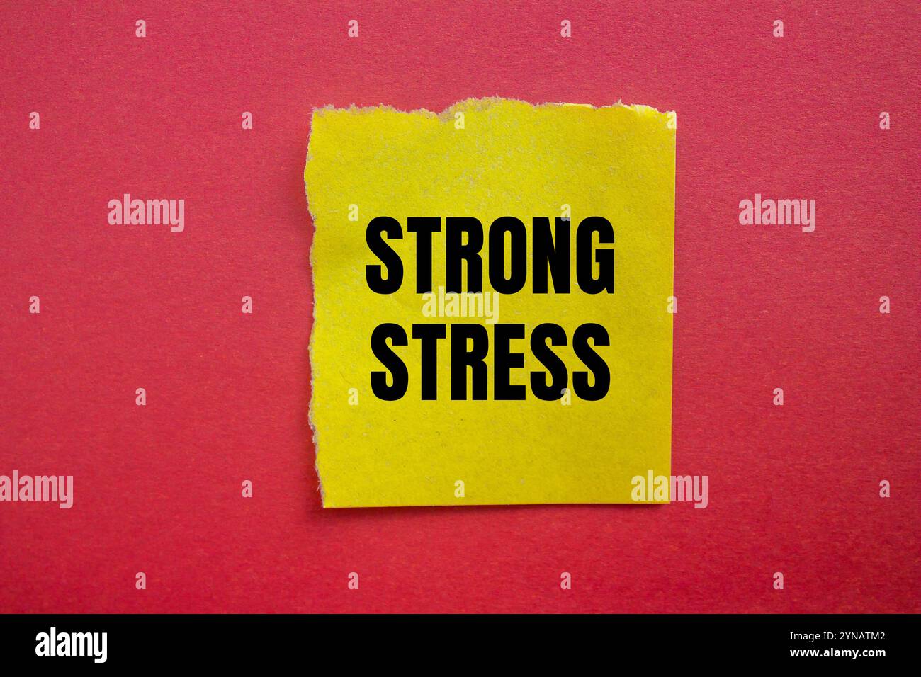 Strong stress message written on ripped torn yellow paper piece with ...