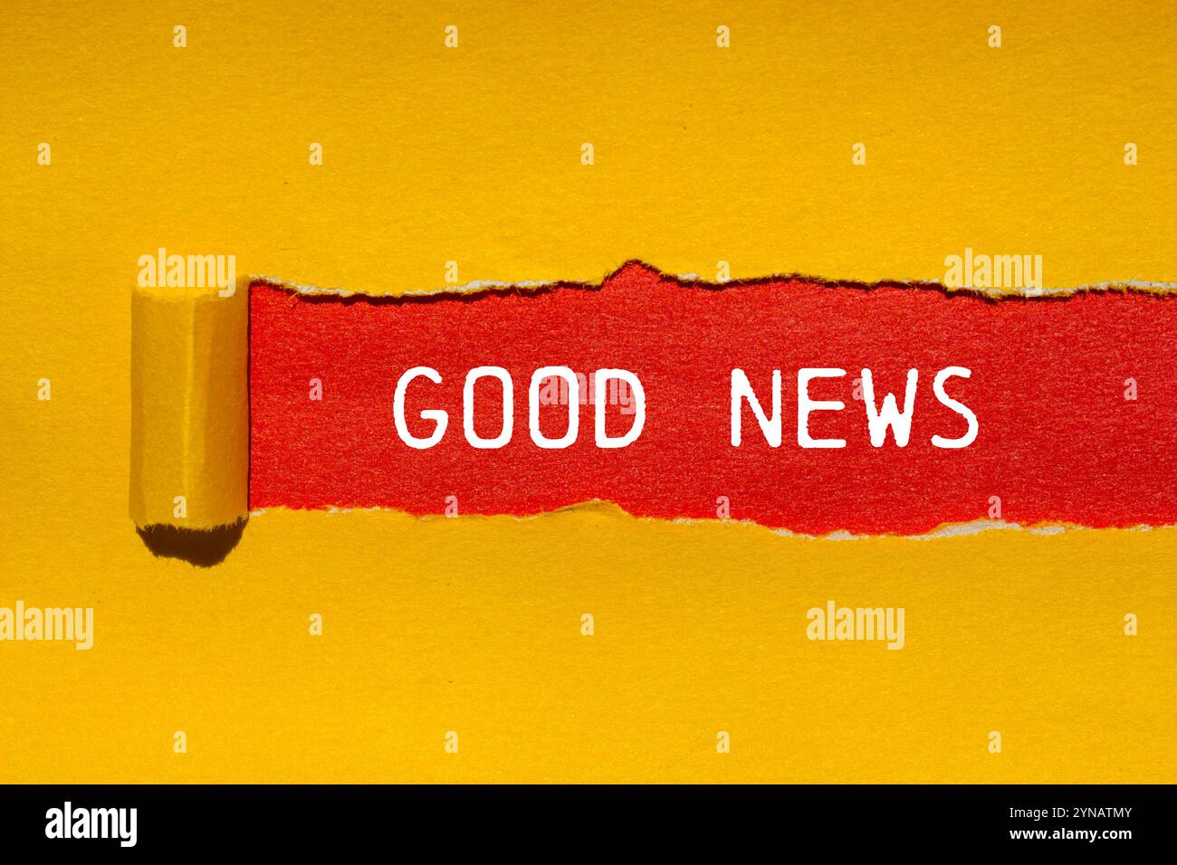 Good news message written on ripped torn yellow paper with red ...