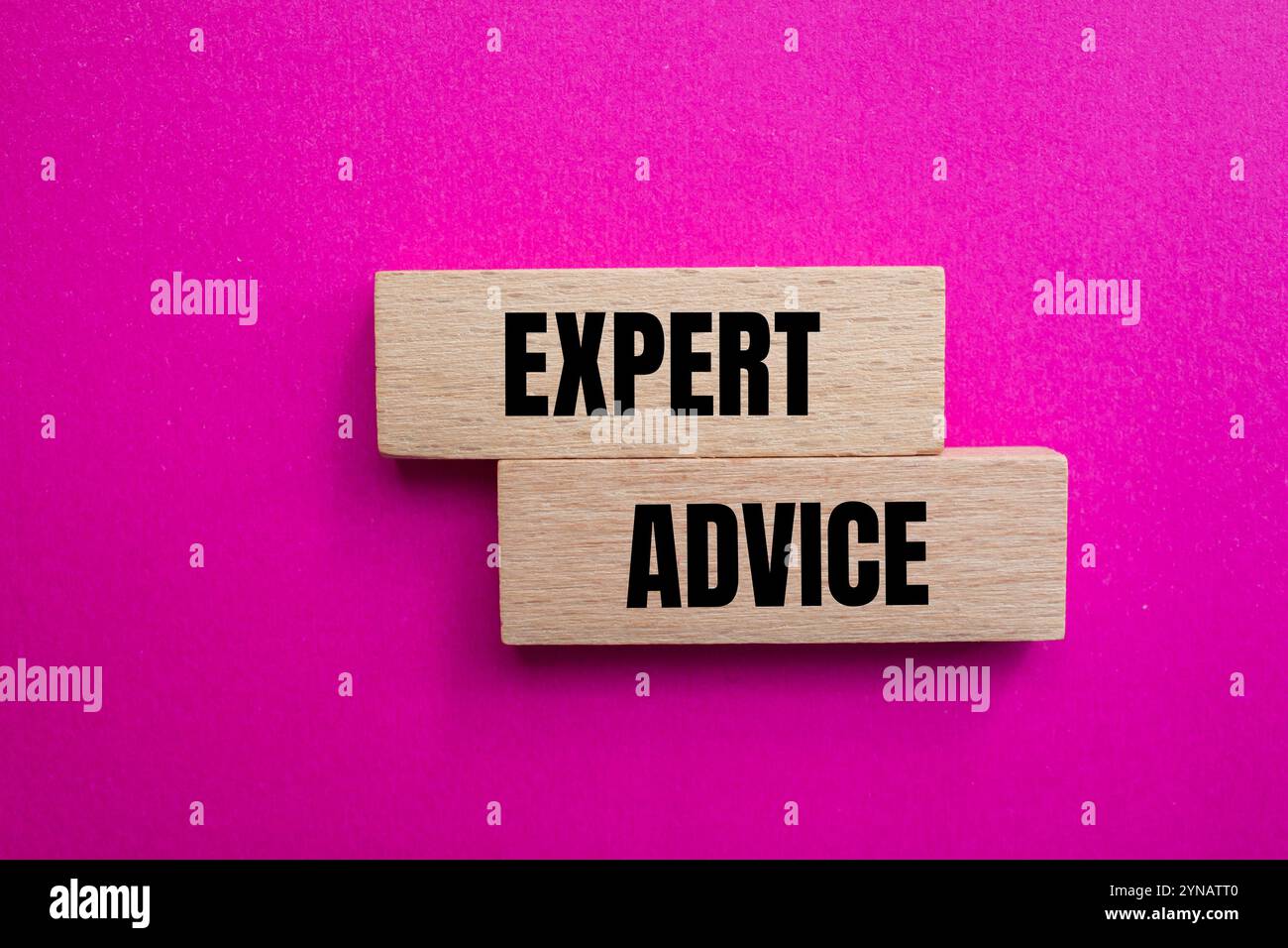 Expert advice message written on wooden blocks with pink background ...