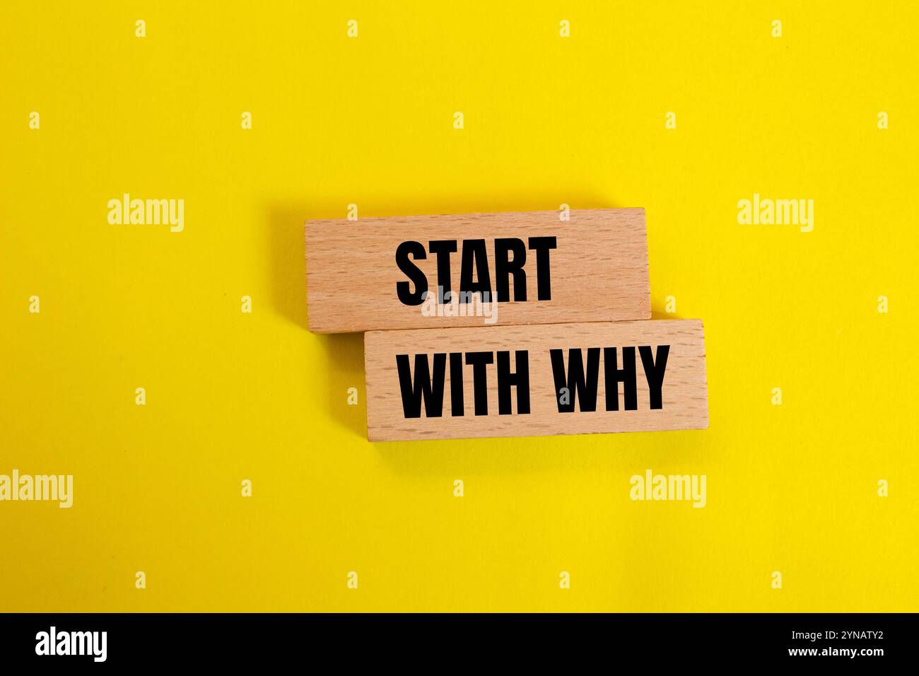 Start with why message written on wooden blocks with yellow background ...