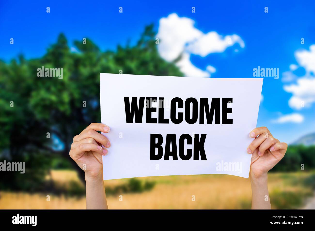 Welcome back message written on white paper with nature background ...