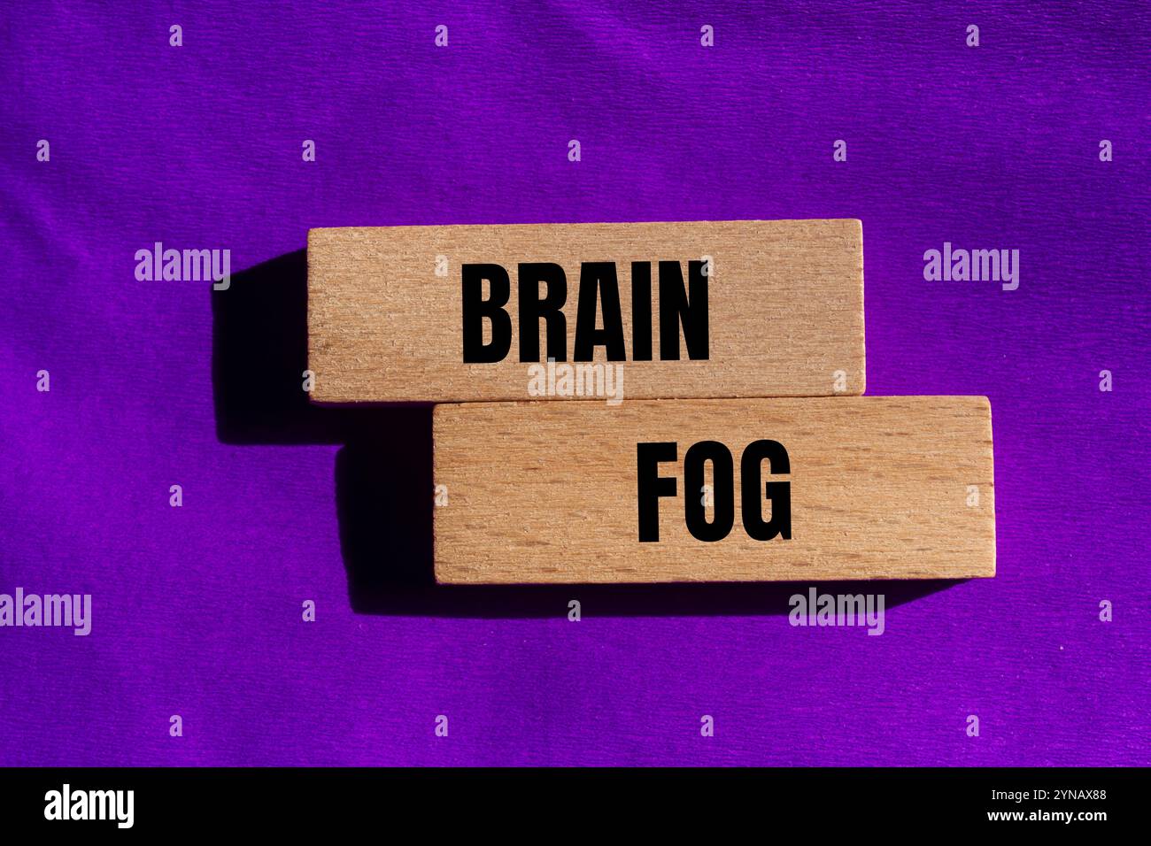 Brain fog message written on wooden blocks with purple background ...
