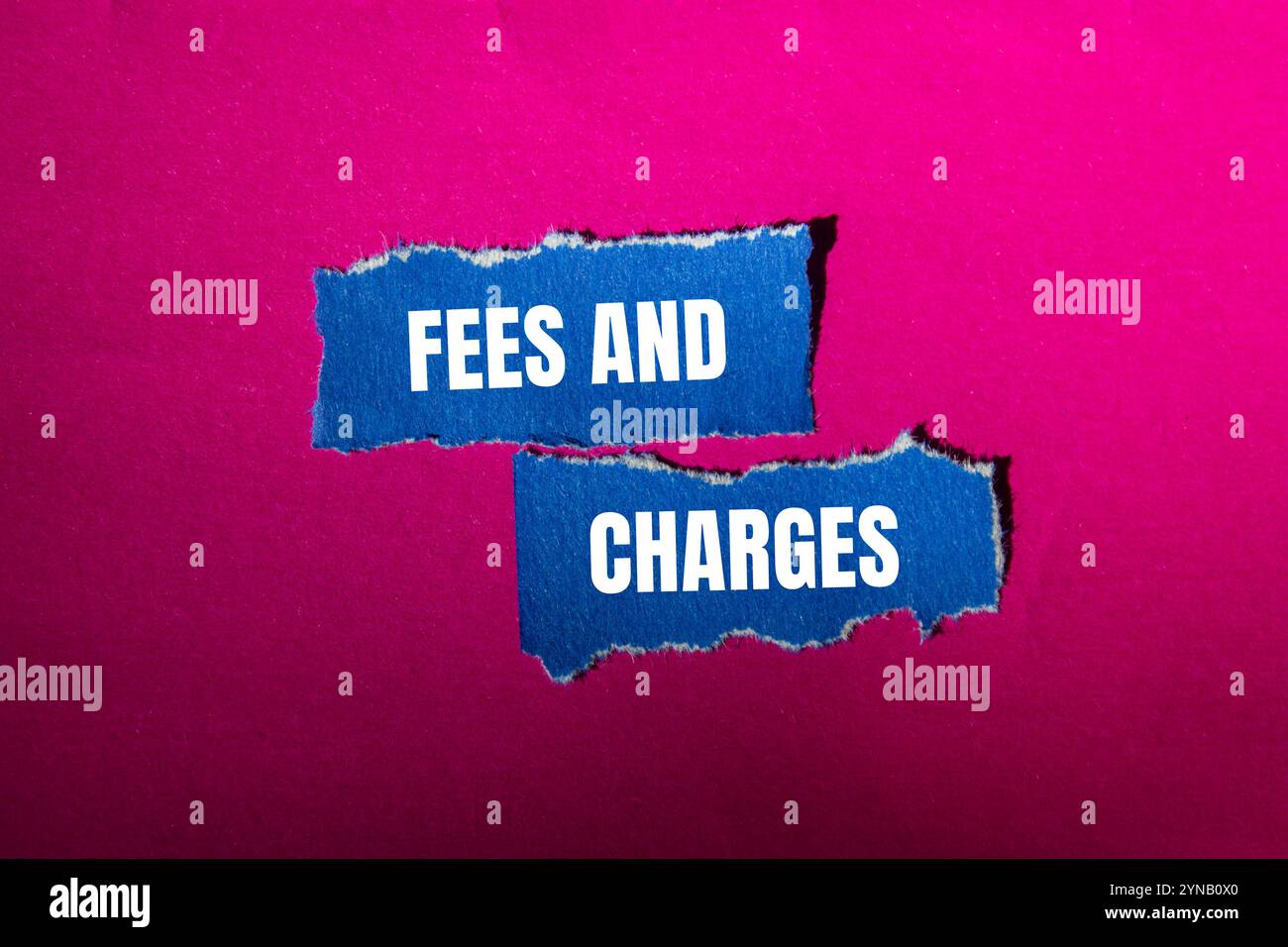 Fees and charges message written on ripped torn blue paper pieces with ...