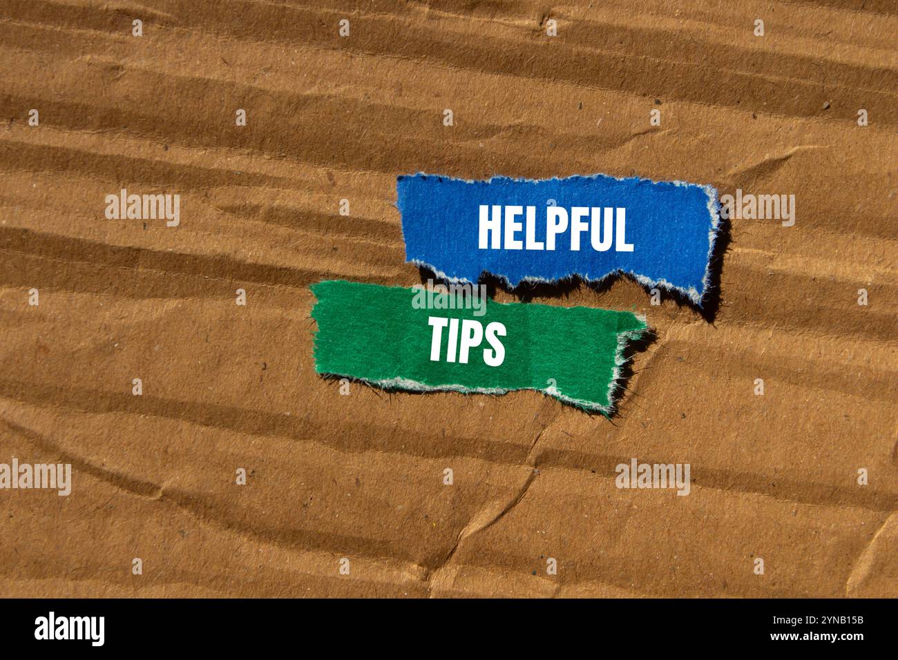 Helpful tips message written on ripped torn paper pieces with cardboard ...
