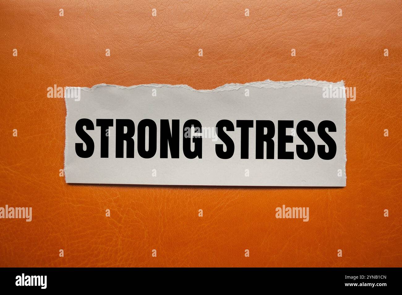 Strong stress message written on ripped torn paper piece with brown ...