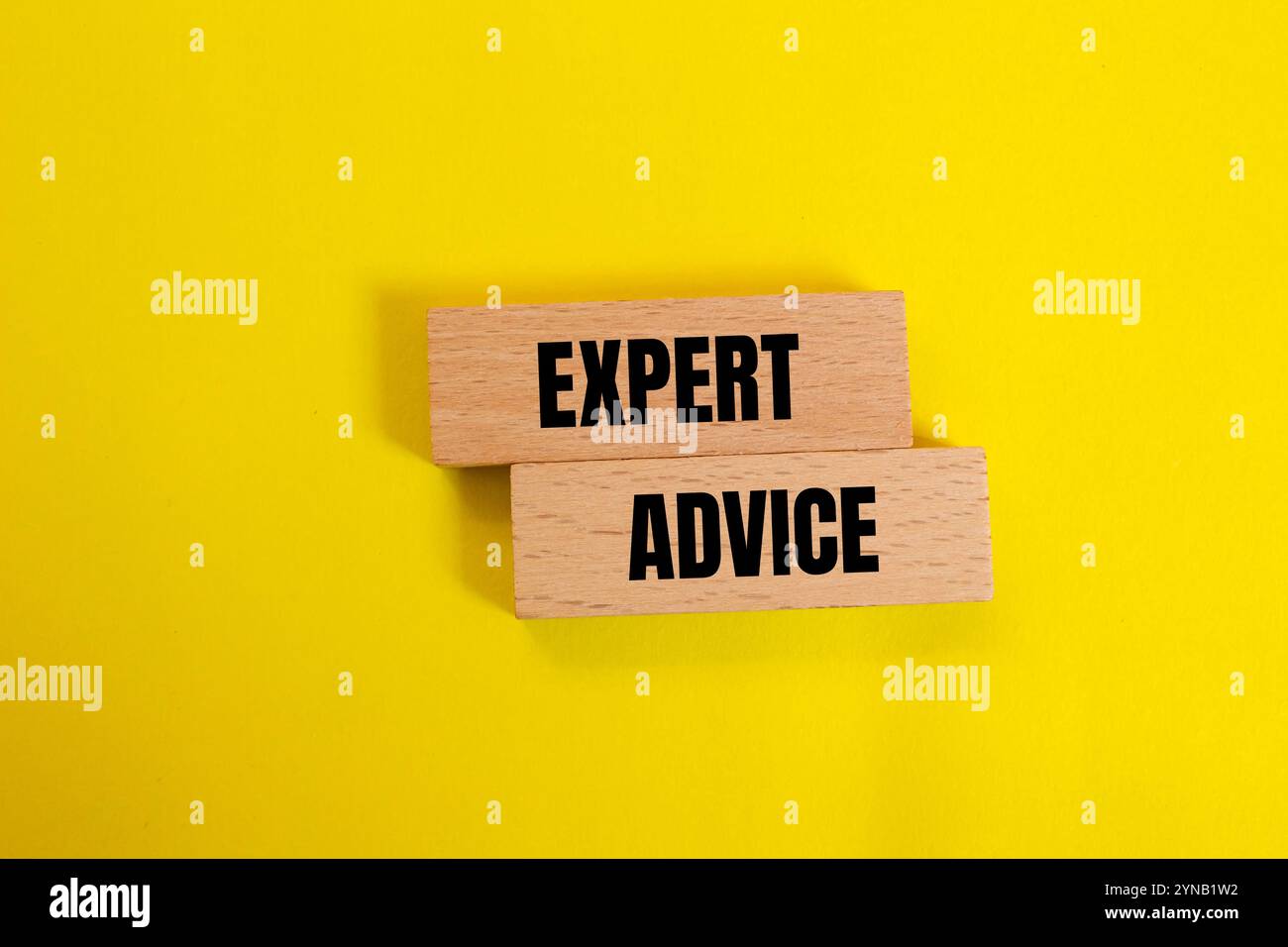 Expert advice message written on wooden blocks with yellow background ...