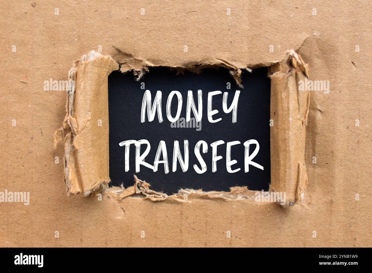 Money transfer message written on ripped torn cardboard paper with black background. Conceptual ...